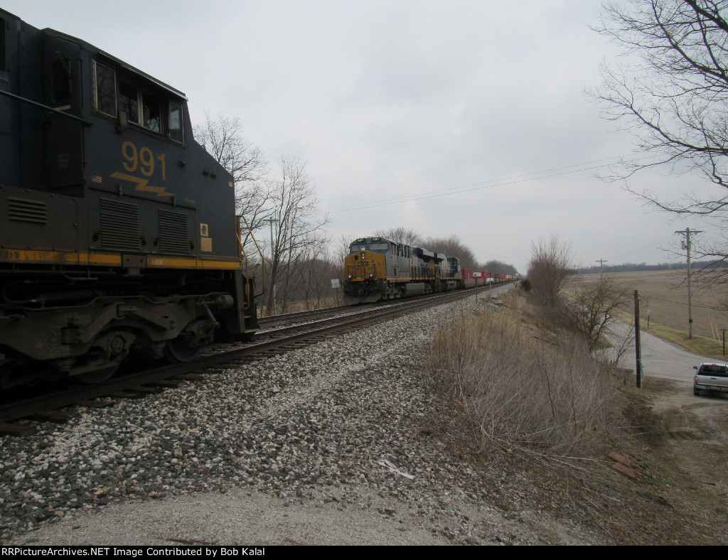 CSX 991 & CSX 5476 moves east while CSX 3207 & ??? heads west